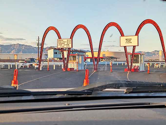 Those iconic red arches aren't just an entrance—they're a time portal to when movies were events and the night sky was your ceiling.