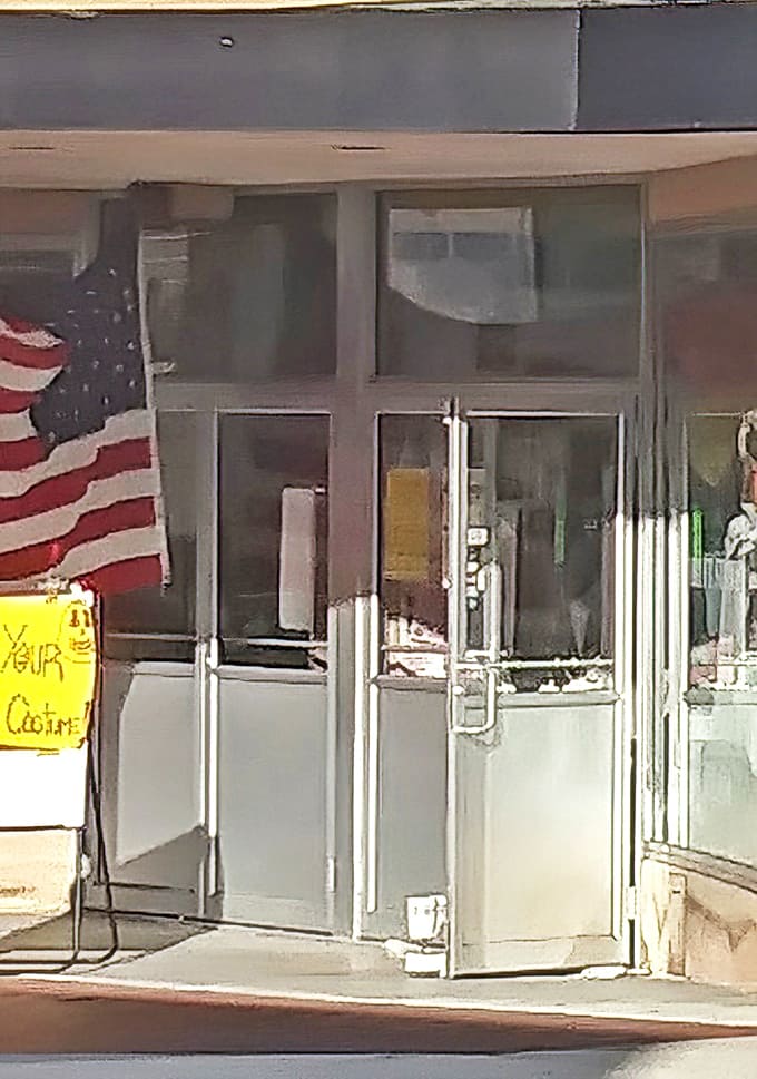 American pride meets bargain hunting at this unassuming entrance. The glass doors might as well be portals to an alternate dimension where everything costs less.
