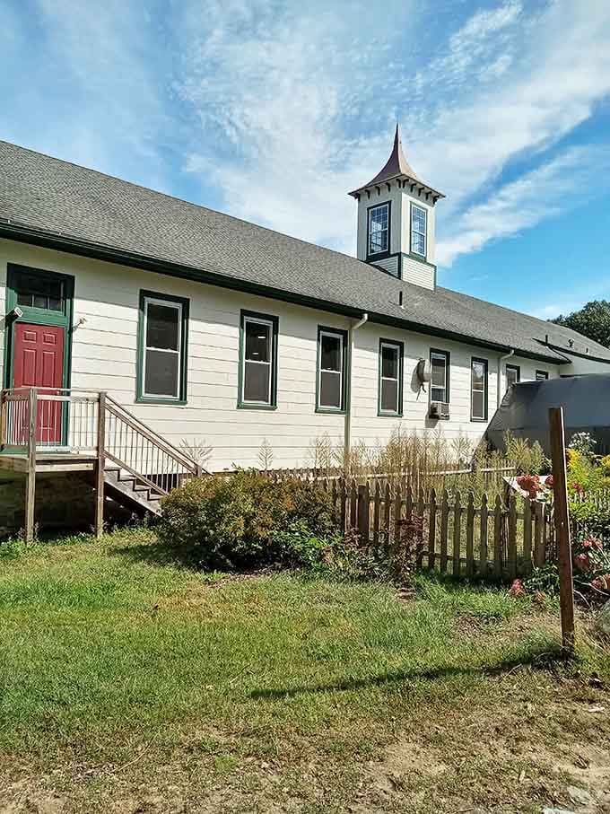 Not your average storefront! This charming white clapboard building with its distinctive cupola looks more like a storybook church than a thrift shop paradise.