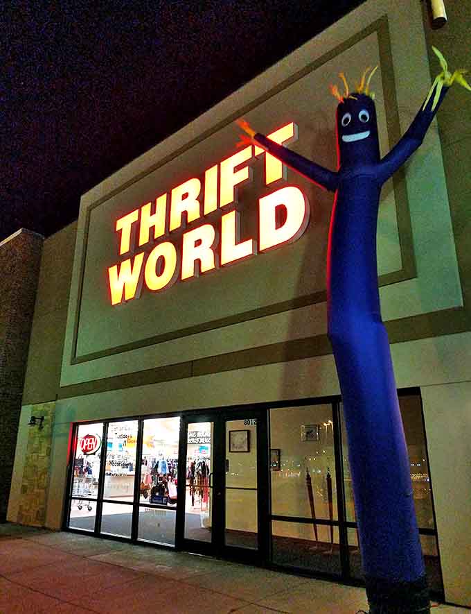 By night, the blue inflatable tube man stands guard like a thrifty superhero, arms waving frantically at passing cars: "Bargains inside!"