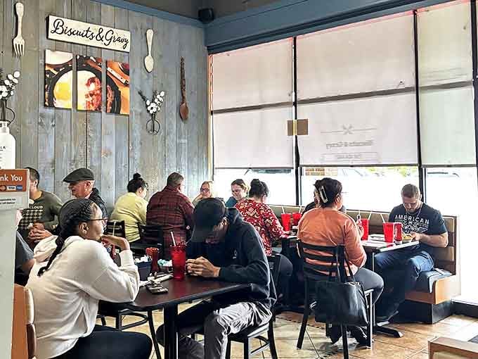 The rustic wood paneling and oversized utensil decor create that perfect "grandma's kitchen meets modern diner" vibe that makes everyone feel at home.