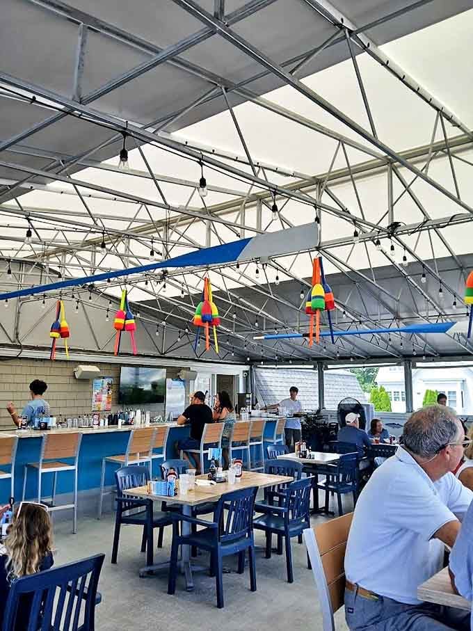 Nautical charm overhead! Those rainbow-colored buoys dangling from the ceiling create the perfect atmosphere for seafood feasting.