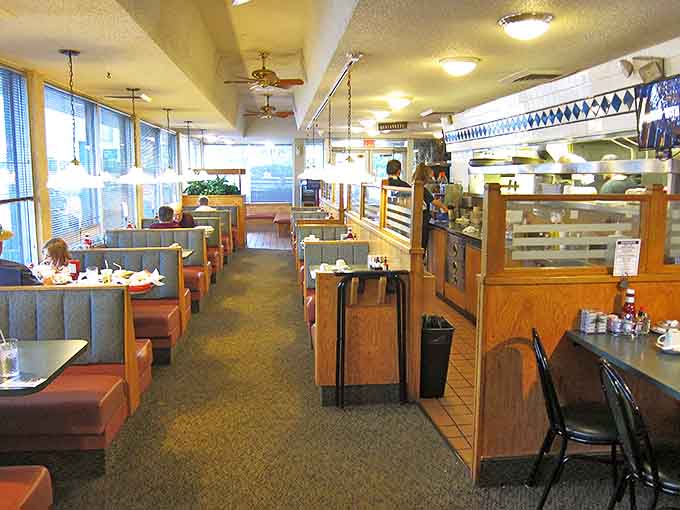 Classic diner chic at its finest—blue booths, wooden accents, and a counter where regulars have solved the world's problems over countless cups of coffee.