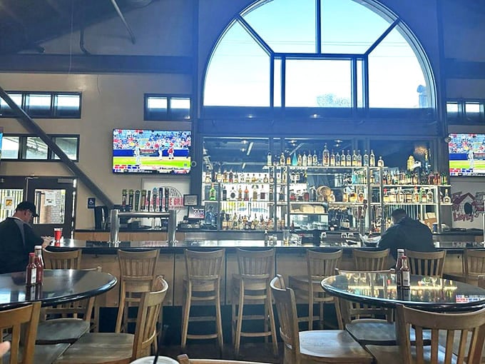 High ceilings, wooden furnishings, and multiple TVs create that perfect sports bar vibe where both the game and your taste buds score big wins.