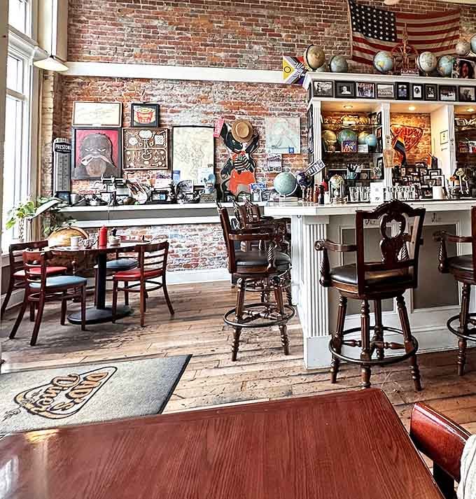 Exposed brick walls adorned with vintage memorabilia create the perfect backdrop for morning conversations that flow as smoothly as their coffee.