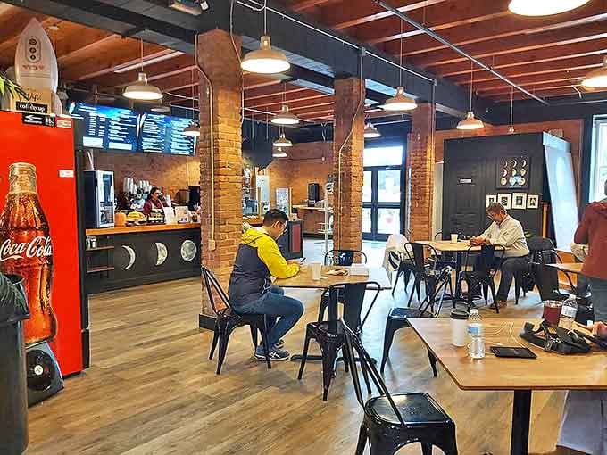 Industrial-chic meets cozy comfort inside, where wooden beams and pendant lights create the perfect atmosphere for savoring that first bite of breakfast bliss.