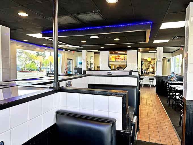 Classic black and white tiles meet modern blue lighting in this diner interior that feels both nostalgic and fresh&mdash;like your favorite song remixed.
