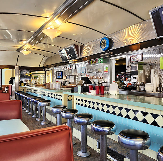Counter culture at its finest&mdash;chrome stools lined up like loyal soldiers, ready for the breakfast brigade. The curved ceiling says "1950s," but the welcome is timeless.