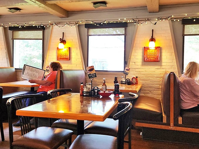 Cozy booths bathed in warm light create that "everybody knows your name" vibe. String lights add just enough whimsy without veering into hipster territory.