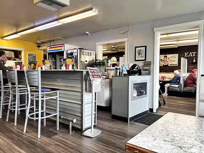 Classic diner architecture meets small-town charm. The counter seating offers front-row tickets to the breakfast ballet happening in the kitchen.