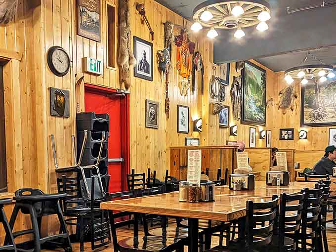 Step inside and you're transported to the Old West, where wagon wheel chandeliers illuminate wood-paneled walls adorned with enough frontier memorabilia to fill a museum.