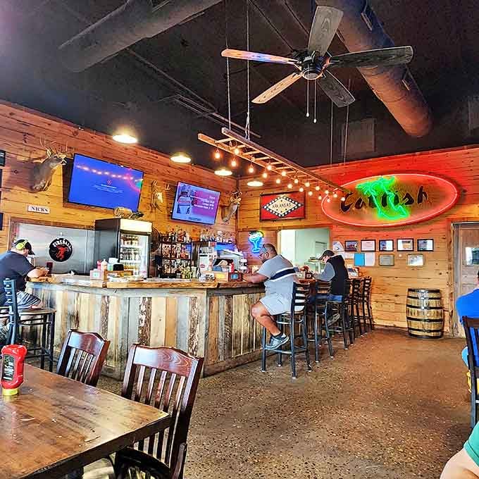 Where neon meets nostalgia. The glowing "catfish" sign and reclaimed wood bar create that perfect blend of roadhouse charm and Southern comfort.