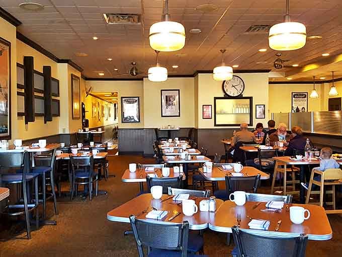 Cozy booths and warm lighting create the perfect backdrop for life-changing breakfast decisions. The yellow walls seem to whisper, "Yes, you deserve that second cup of coffee."