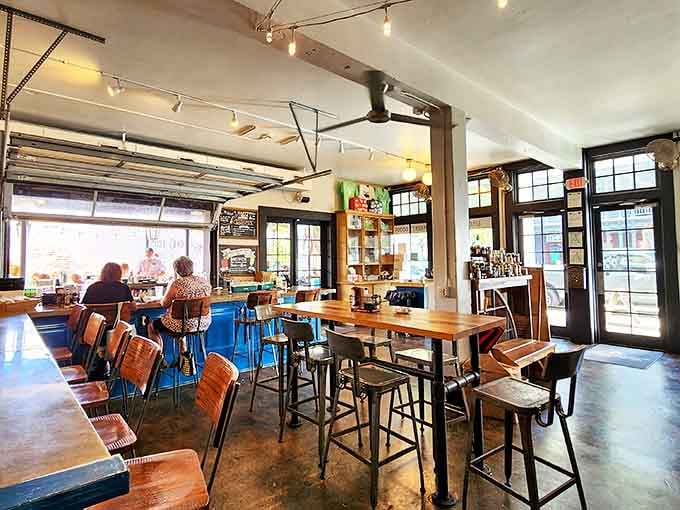 Industrial meets coastal comfort inside The Lady May, where wooden tables and metal chairs create a space that says "stay awhile" without trying too hard.