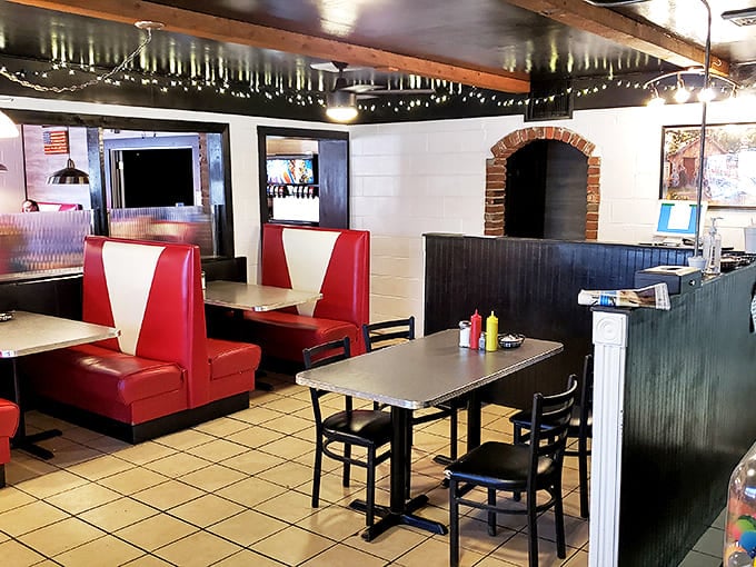 Red vinyl booths and checkered floors—the universal language of "sit down, relax, and prepare for a meal that'll make your cardiologist wince but your soul sing."