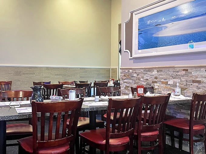 Inside, wooden chairs with red cushions surround granite-topped tables, while stone accents create that perfect balance of "nice enough for a date, comfortable enough for family breakfast."