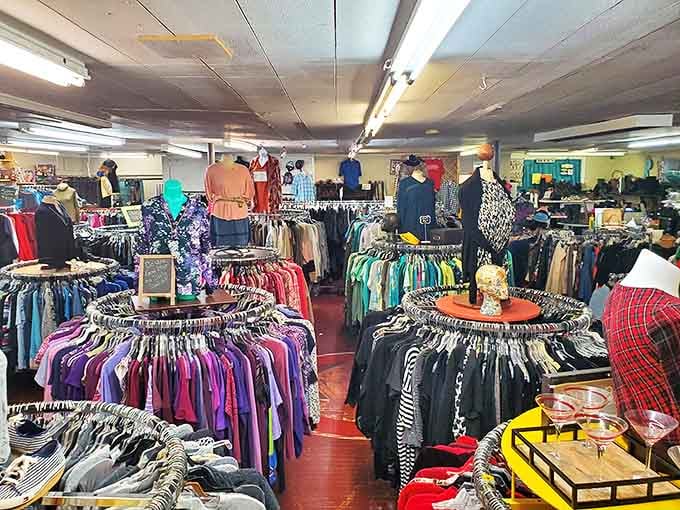 Circular racks create a thrifter's paradise where clothing is organized by type and color, making the hunt both methodical and magical.