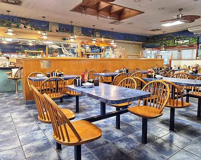 Classic Windsor chairs and ocean-themed murals create that perfect "I'm definitely at the beach" vibe. Comfort doesn't need to be complicated.