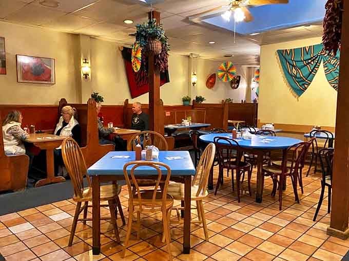 Blue tables, wooden chairs, and colorful New Mexican d&eacute;cor create that perfect "abuela's dining room" vibe. Comfort begins before the food arrives.