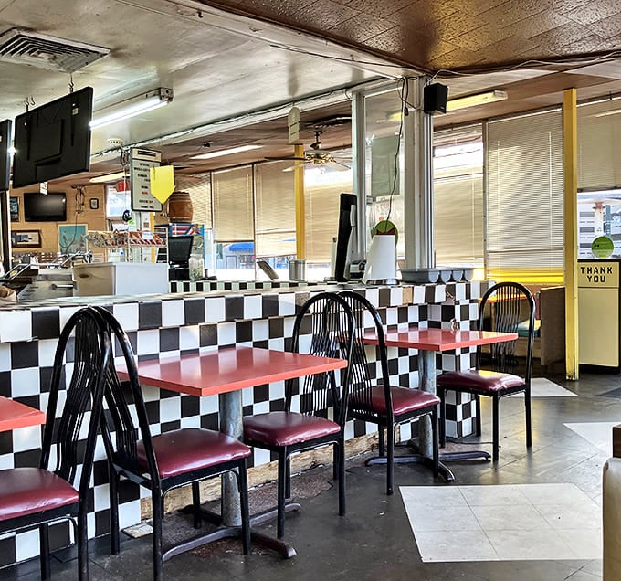 Classic black and white checkerboard counters meet cherry-red tables in this diner where conversations flow as freely as the root beer.