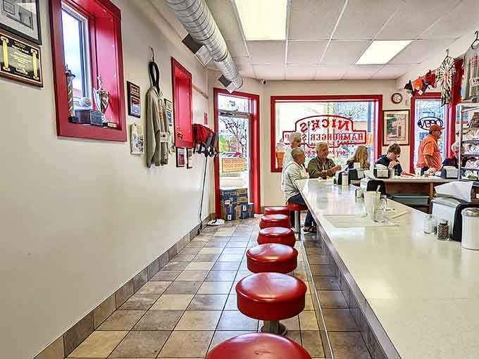 Red counter stools lined up like patient sentinels, waiting for the next generation of Nick's devotees to perch and indulge.