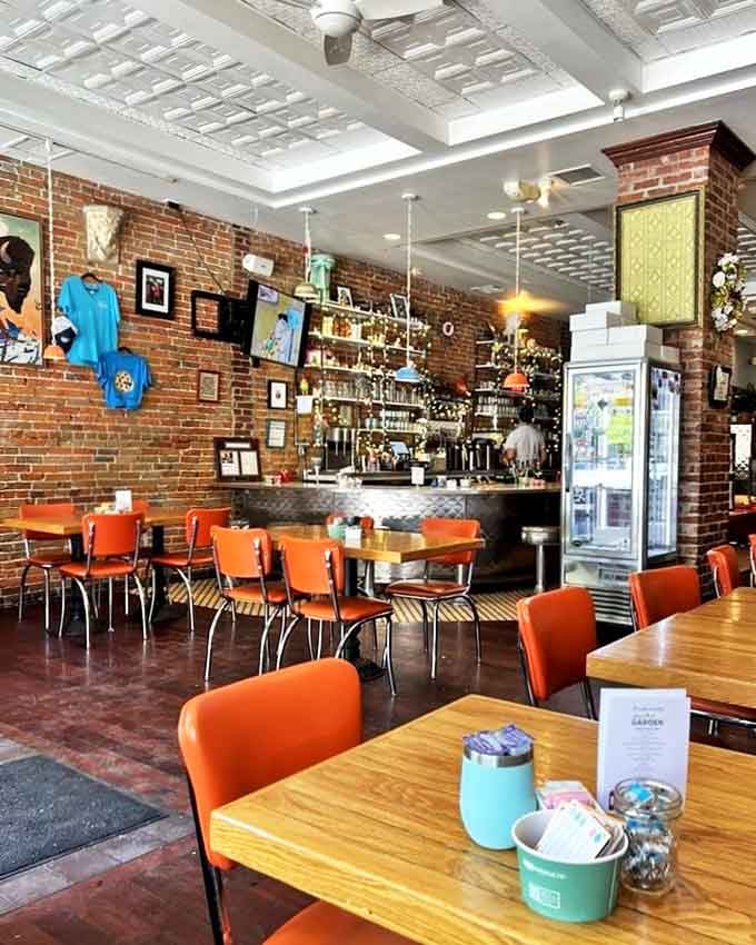 Inside, exposed brick walls meet a pressed tin ceiling while those iconic orange chairs pop against wooden tables&mdash;diner perfection with personality.