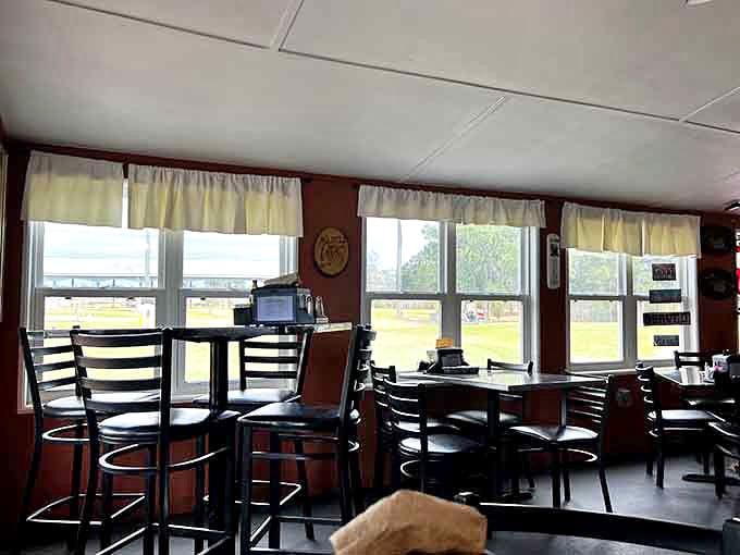 Morning light streams through simple curtained windows, creating that perfect diner ambiance where coffee and conversation flow equally well.