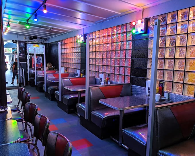 Classic diner booths get the space-age treatment with metallic finishes and cosmic lighting. It's like eating in the mess hall of the Starship Enterprise.