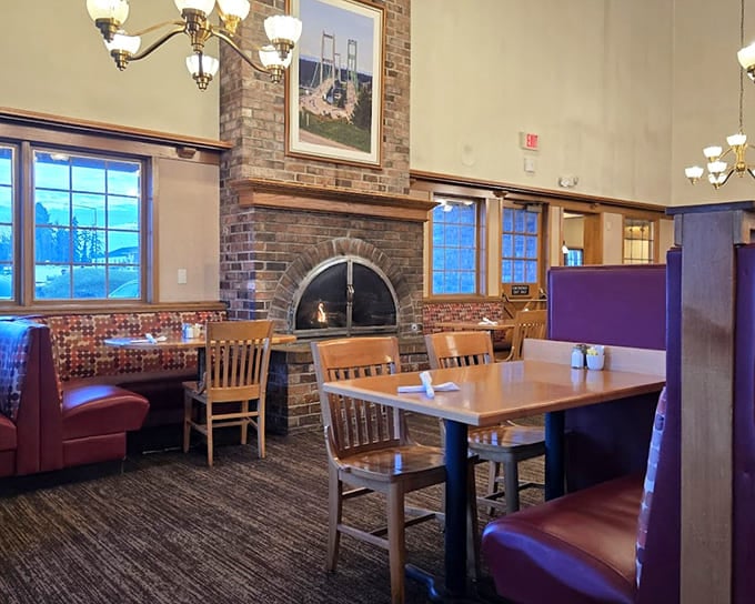 That fireplace isn't just for show—it's the beating heart of a dining room where conversations flow as freely as the coffee.