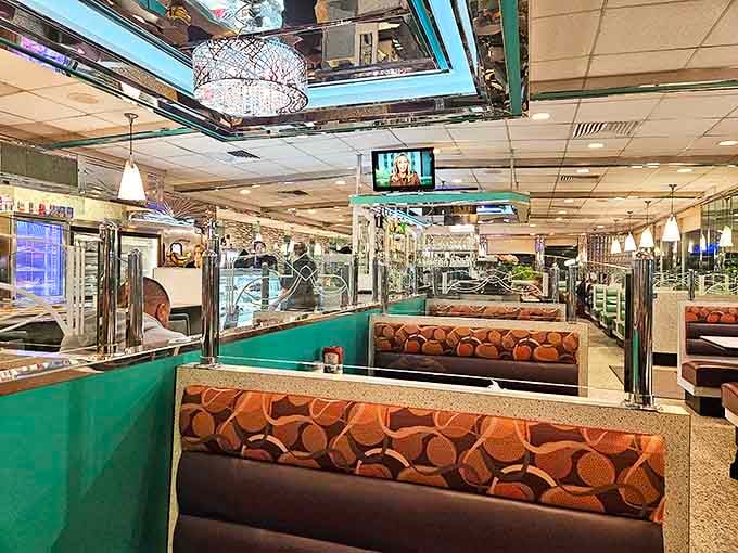Inside, mirrored accents and retro booths create that distinctive diner atmosphere where conversations flow as freely as the coffee.