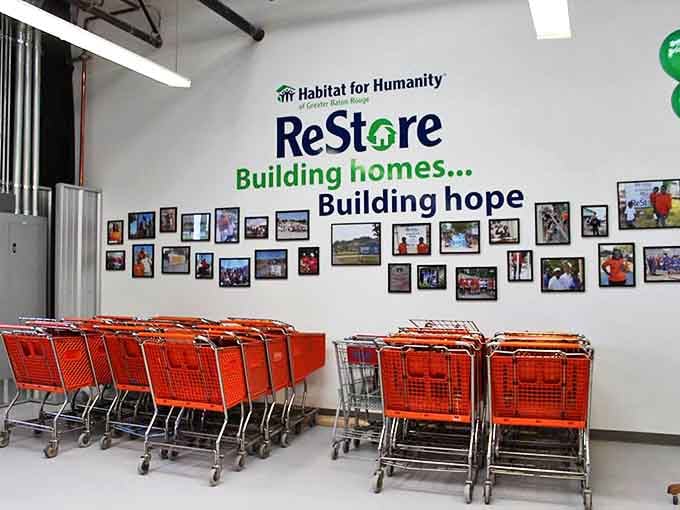 Orange shopping carts stand ready for treasure hunters, beneath a wall showcasing the real mission: building homes and hope.