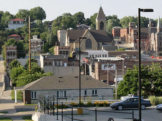 Burlington's skyline rises majestically from the Mississippi riverfront, where historic church steeples punctuate a landscape frozen in time.