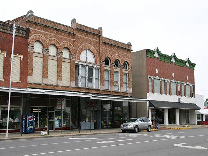 McLeansboro's vintage downtown architecture showcases the beauty of bygone eras. Red brick buildings stand proudly against a bright blue sky.