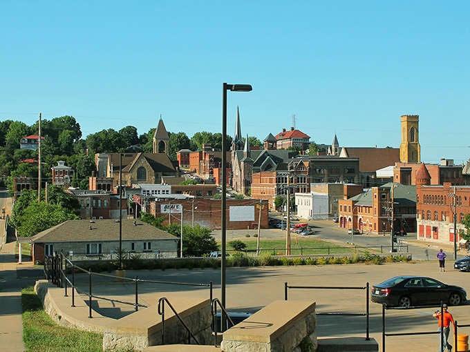 Sunlight bathes Burlington's historic downtown in golden warmth, showcasing brick buildings that have witnessed generations of Iowa life.