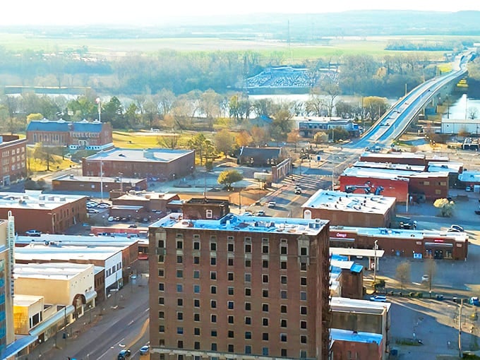Aerial views reveal Fort Smith's perfect blend of river town charm and urban convenience spread below.