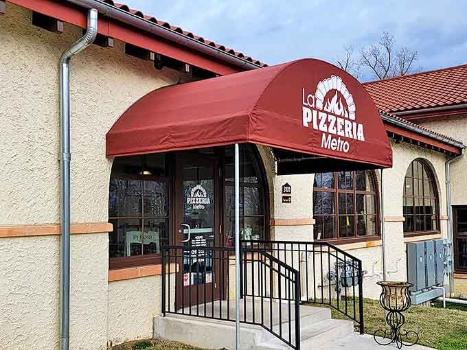 Step closer to this charming stucco facade and you'll swear you can already smell the wood-fired pizza inside. La Pizzeria Metro's red awning beckons like an old friend.