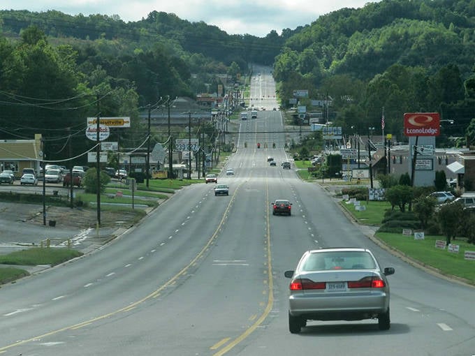 Rolling hills embrace this valley town like nature's own welcome committee, promising peaceful adventures ahead.