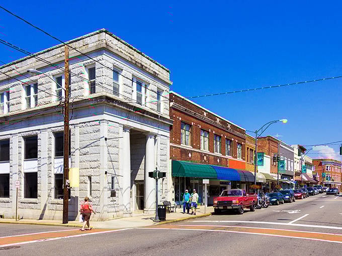 Blue skies frame this picture-perfect main street where shopkeepers sweep their own sidewalks and know your coffee order by heart.
