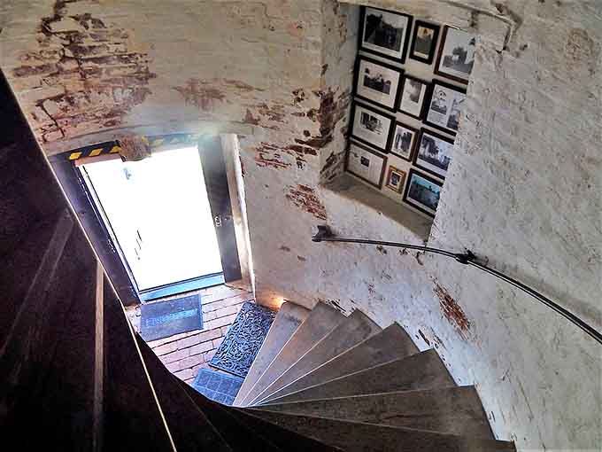 Spiral staircase secrets: Each worn step in this lighthouse tells a story of keepers who climbed these same stairs for nearly two centuries.