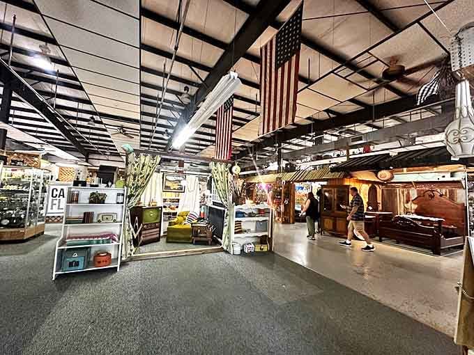 American flags hang proudly overhead as shoppers navigate this wonderland of vintage furniture and decor. It's like walking through America's collective attic.