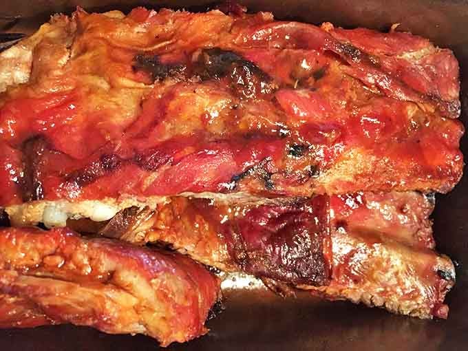 These aren't just ribs; they're edible history. That glistening, ruby-red bark is the result of decades of perfecting the art of smoke.