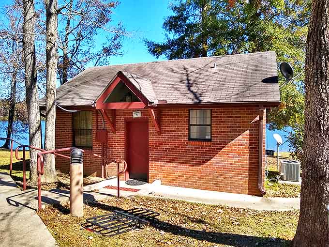 This lakeside brick cabin isn't trying to win architectural awards—it's too busy creating lifetime memories for families seeking shelter in paradise.