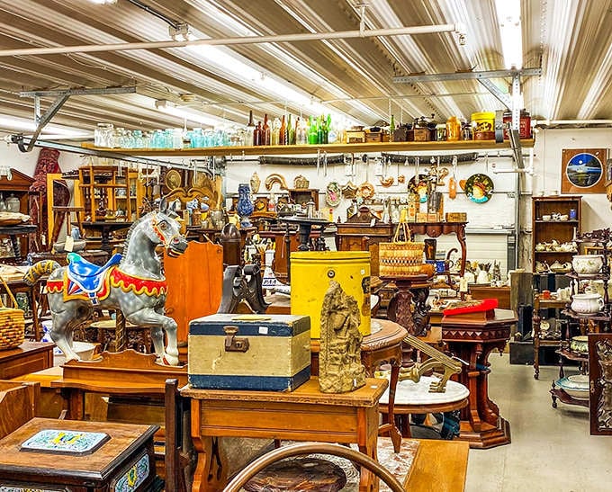 A carousel horse stands sentinel among vintage furniture and collectibles, like a merry-go-round of history where you can actually take home the ride.