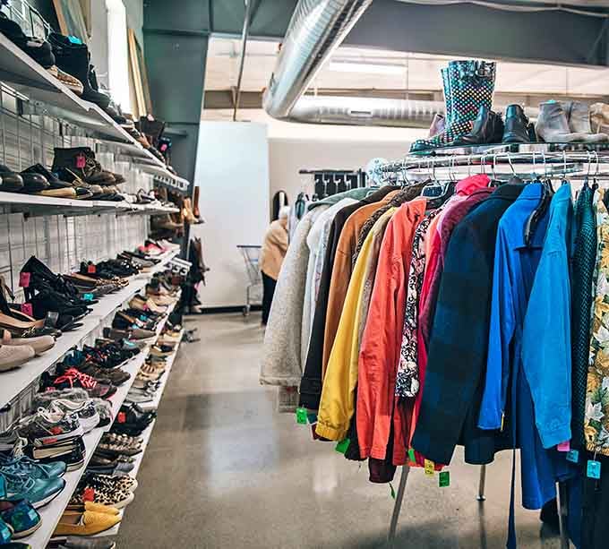 Where fashion meets frugality: racks of colorful clothing stand beside shelves of shoes, creating a rainbow of possibilities for budget-conscious shoppers.