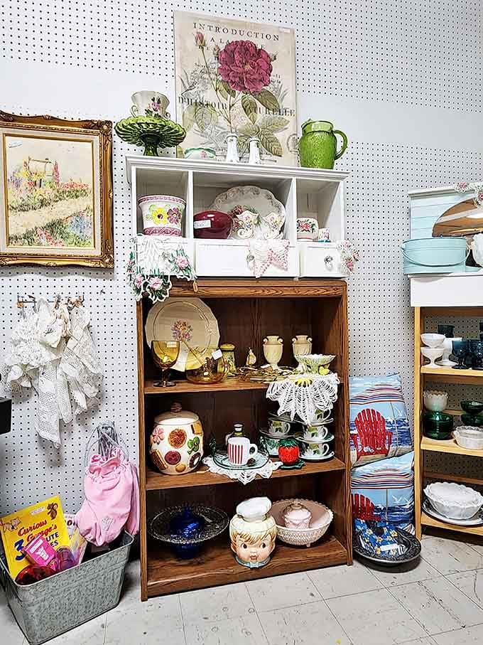 Pegboard paradise! This meticulously arranged collection of vintage dishware and decorative items is a feast for nostalgic eyes.