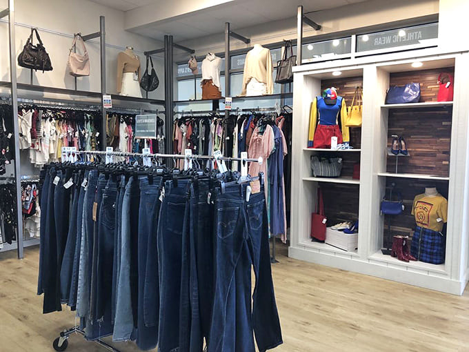 Denim dreams come true in this meticulously organized section. Notice how the industrial-chic fixtures elevate this beyond typical thrift store aesthetics.