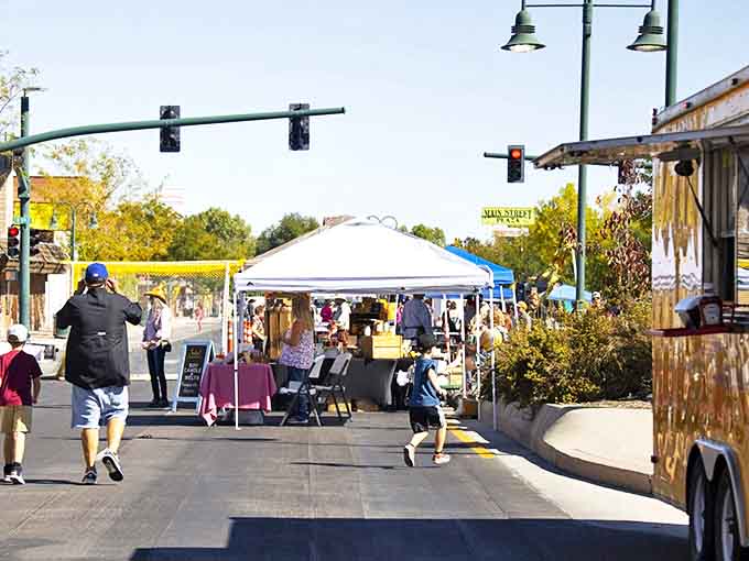The farmers market transforms Main Street into a community living room where neighbors catch up while pretending they're just there for the produce.