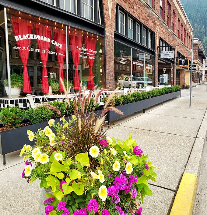 The Blackboard Caf&eacute;'s vibrant red curtains practically scream "come inside!" Flower boxes and string lights add charm that would make Hallmark movie scouts weep with joy.