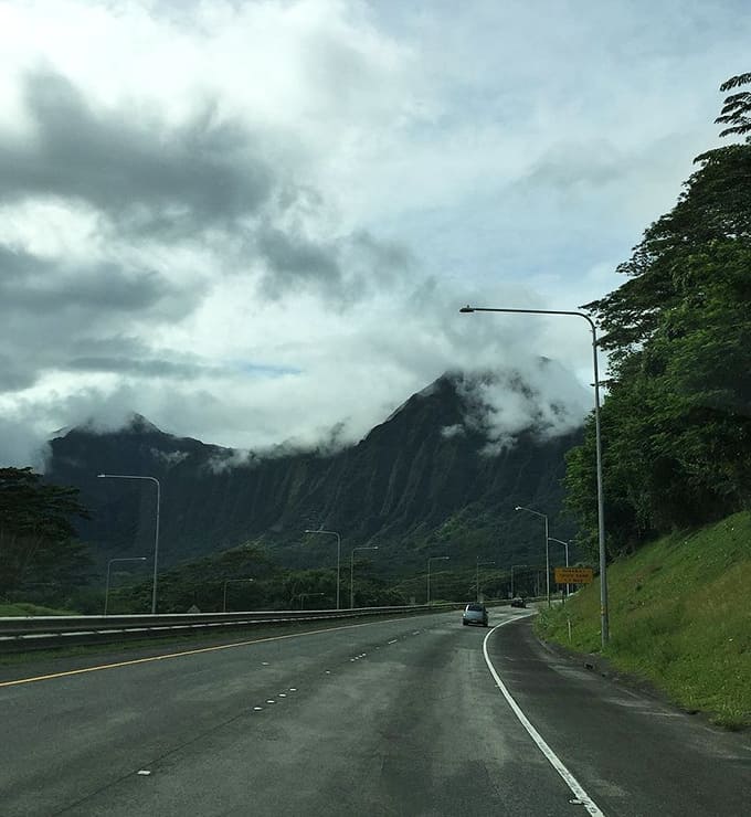 Misty mountains embrace the highway on cloudy days, turning an ordinary drive into a mystical journey through nature's mood swings.
