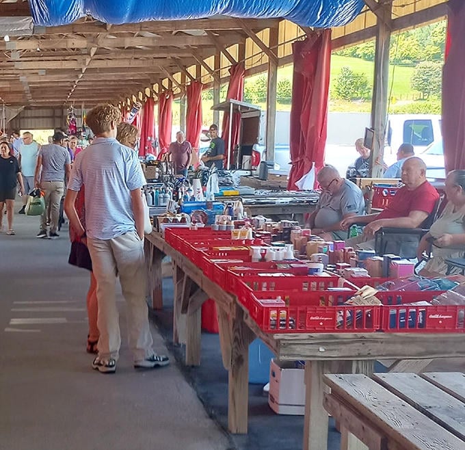 The outdoor section buzzes with activity as shoppers scan red bins of potential treasures, proving one person's random stuff is another's must-have.
